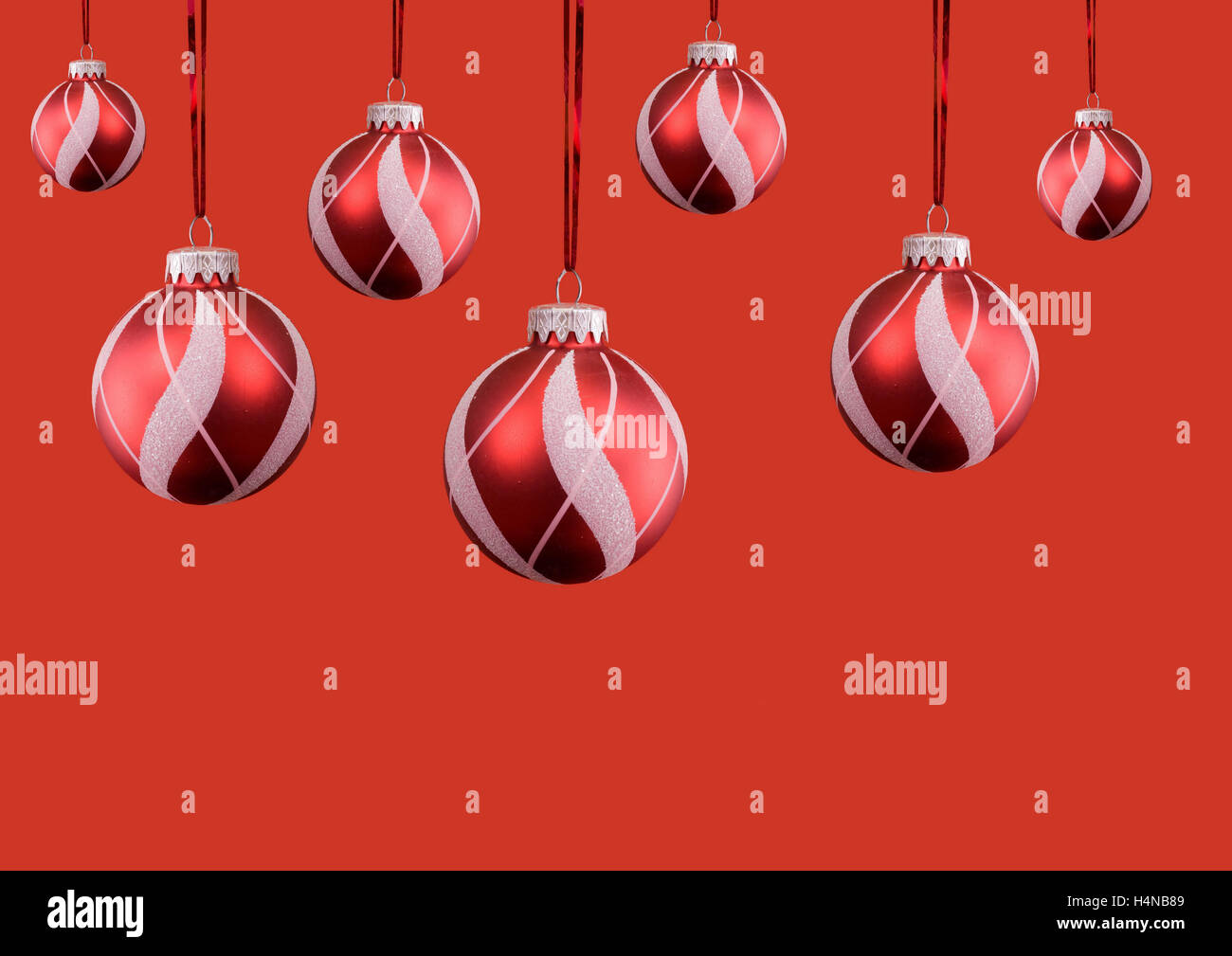 Red Christmas balls isolated on red background Stock Photo - Alamy