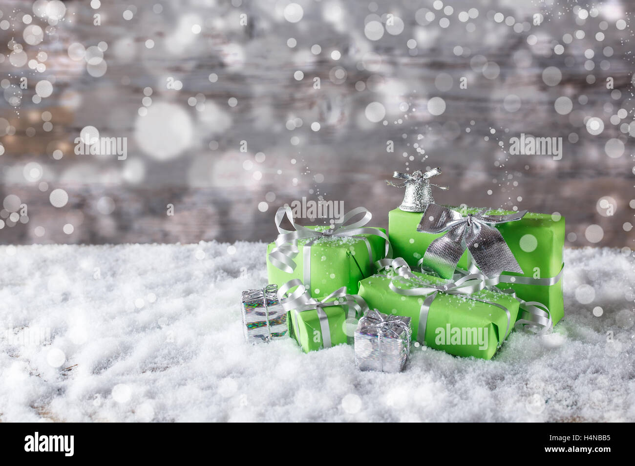 Green Christmas presents in snow Stock Photo - Alamy