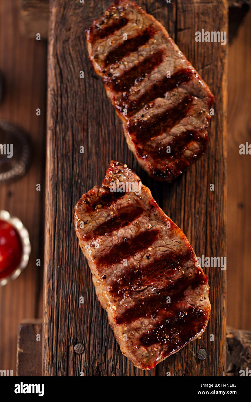 beef marbled steak with vintage old wooden background Stock Photo - Alamy