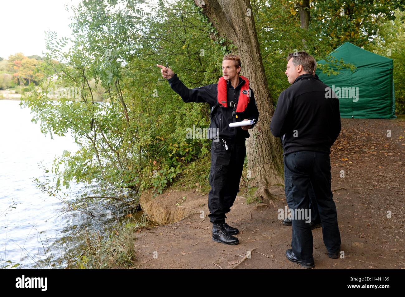 A specialist diving team searches Littleheath Pond in Oxshott, Surrey ...