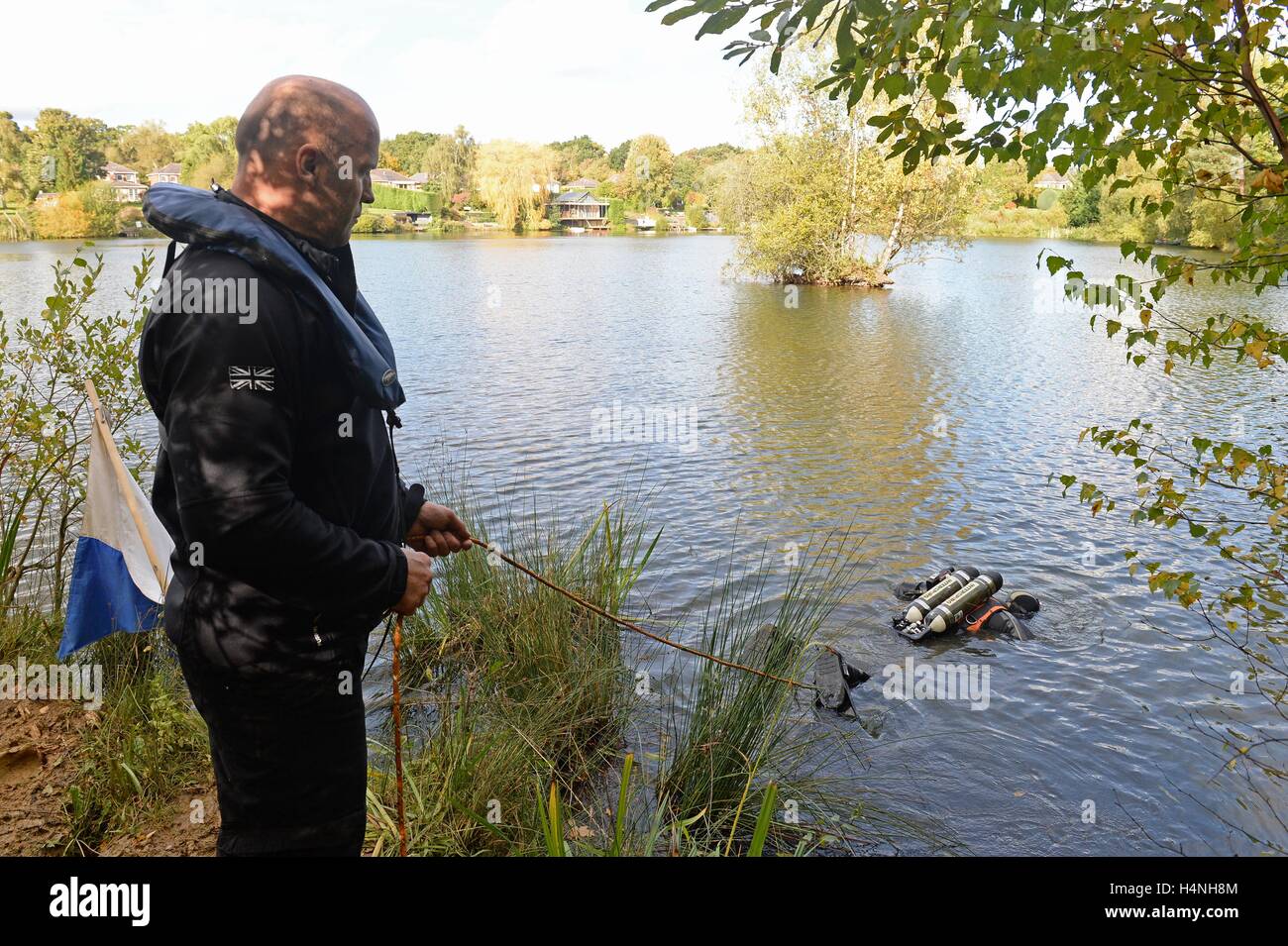 A specialist diving team searches Littleheath Pond in Oxshott, Surrey ...