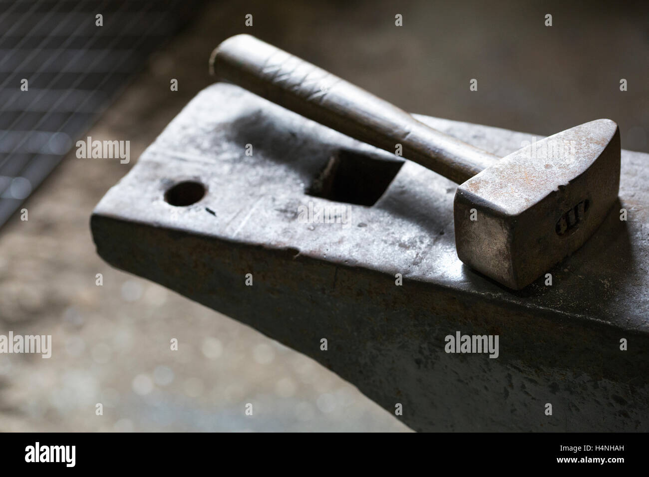 A hammer on top of anvil Stock Photo - Alamy
