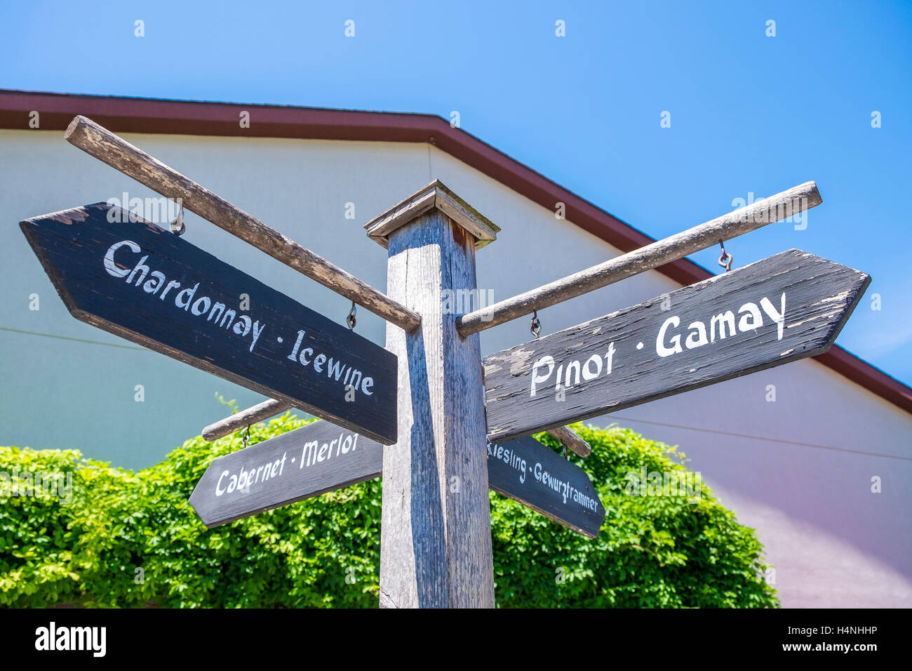 Signs on a post point the direction to various wines at a vineyard in ...