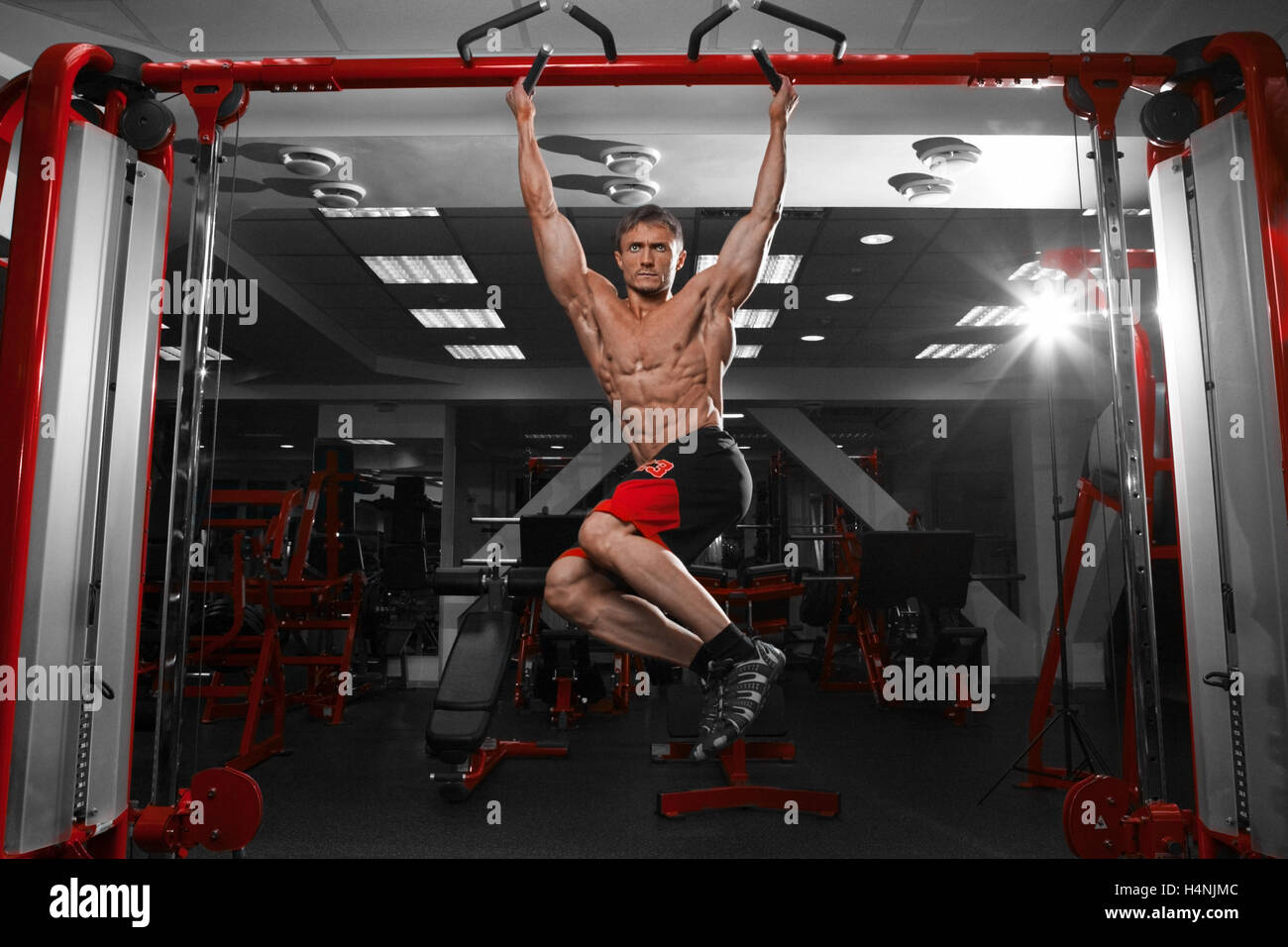 Muscular man doing pulling up on horizontal bar Stock Photo - Alamy