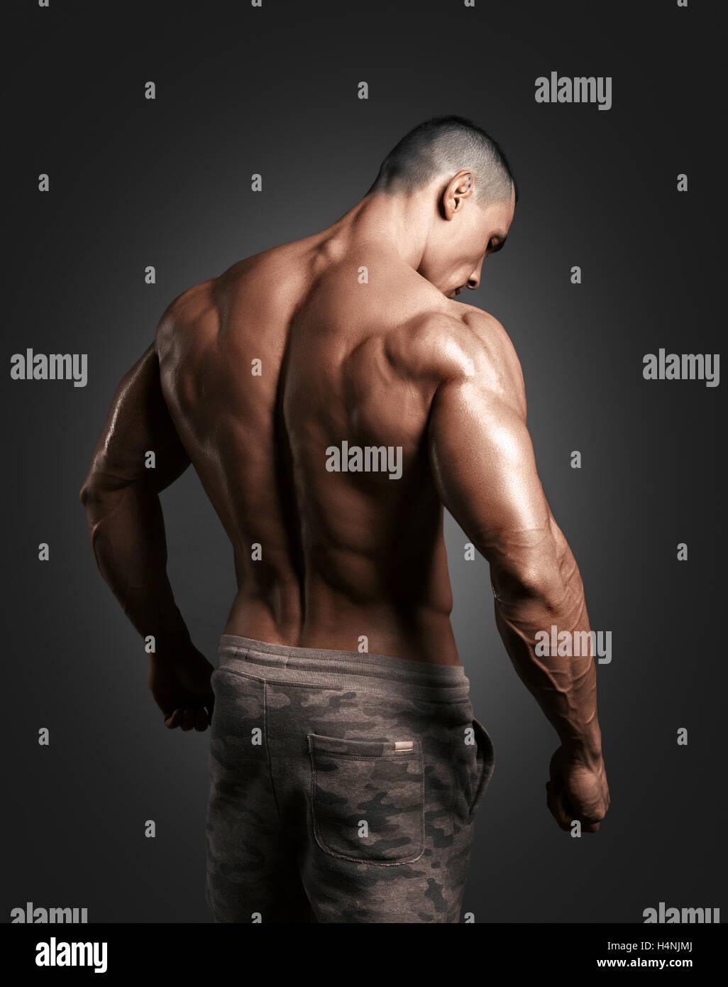 Muscled male model showing his back Stock Photo - Alamy