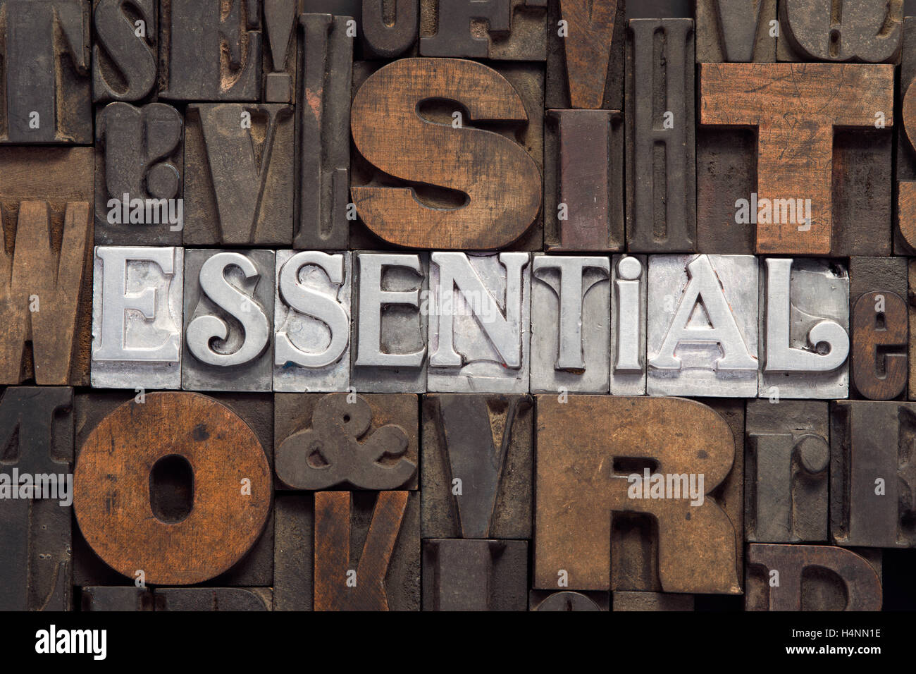 essential word concept made from metallic letterpress blocks inside ...