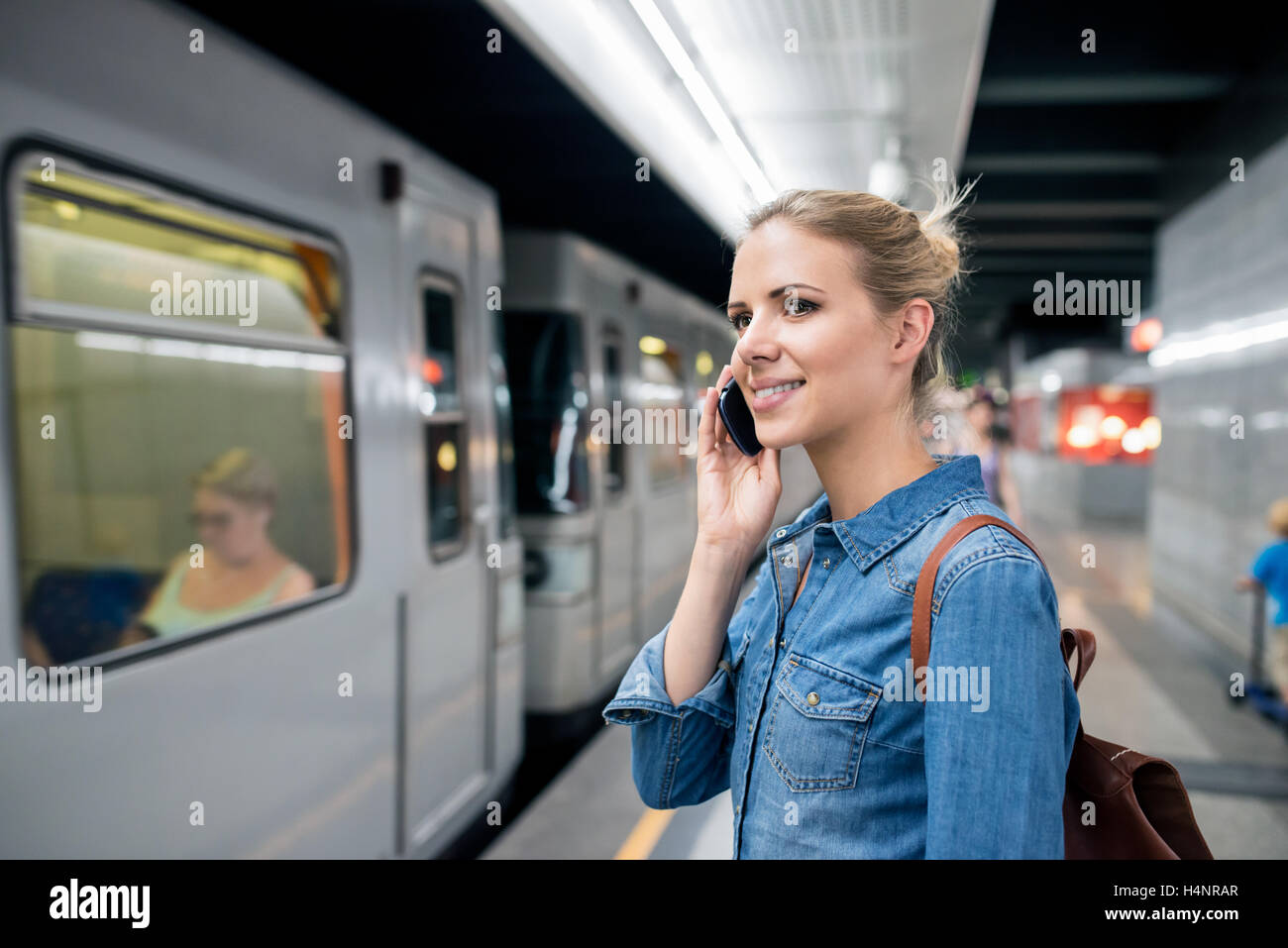 Woman making phone call at the underground platform, waiting Stock ...