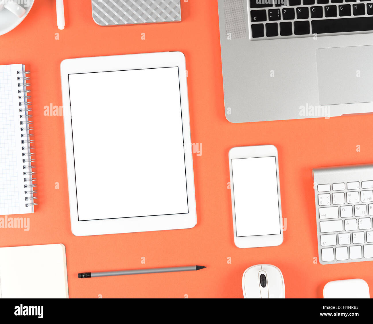 Responsive design: Keyboard, tablet and smartphone on red table Stock ...