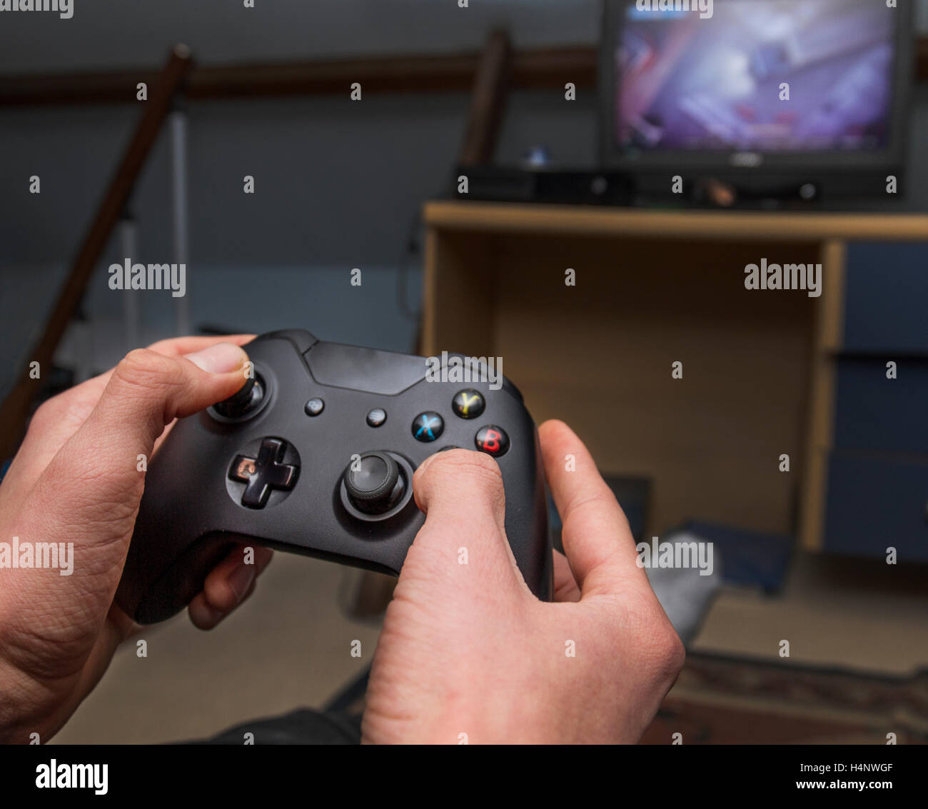 teen in den playing with gaming controller on tv Stock Photo - Alamy