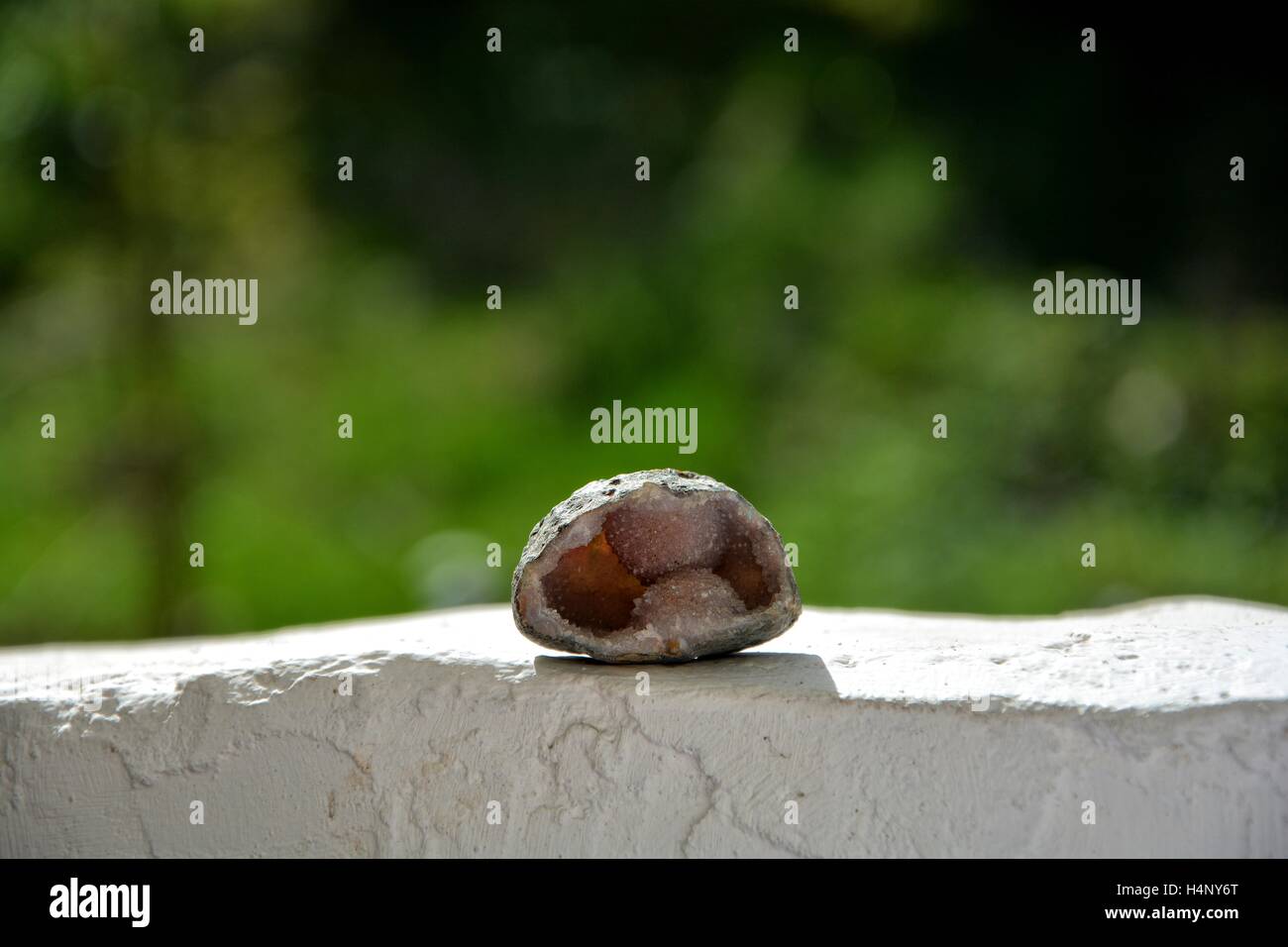 Druse mineral stone on white wall with green background Stock Photo - Alamy