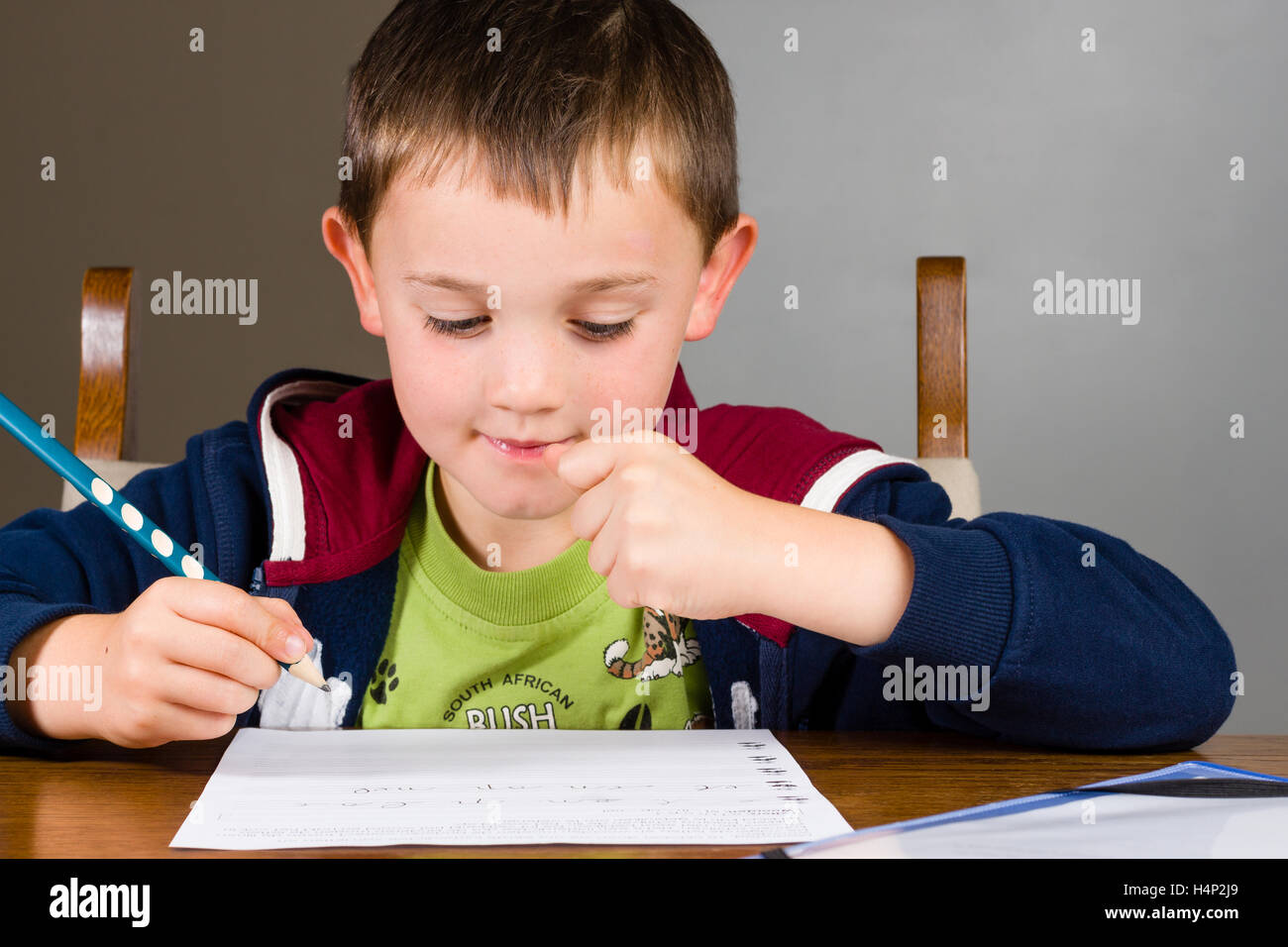Boy doing homework Stock Photo - Alamy