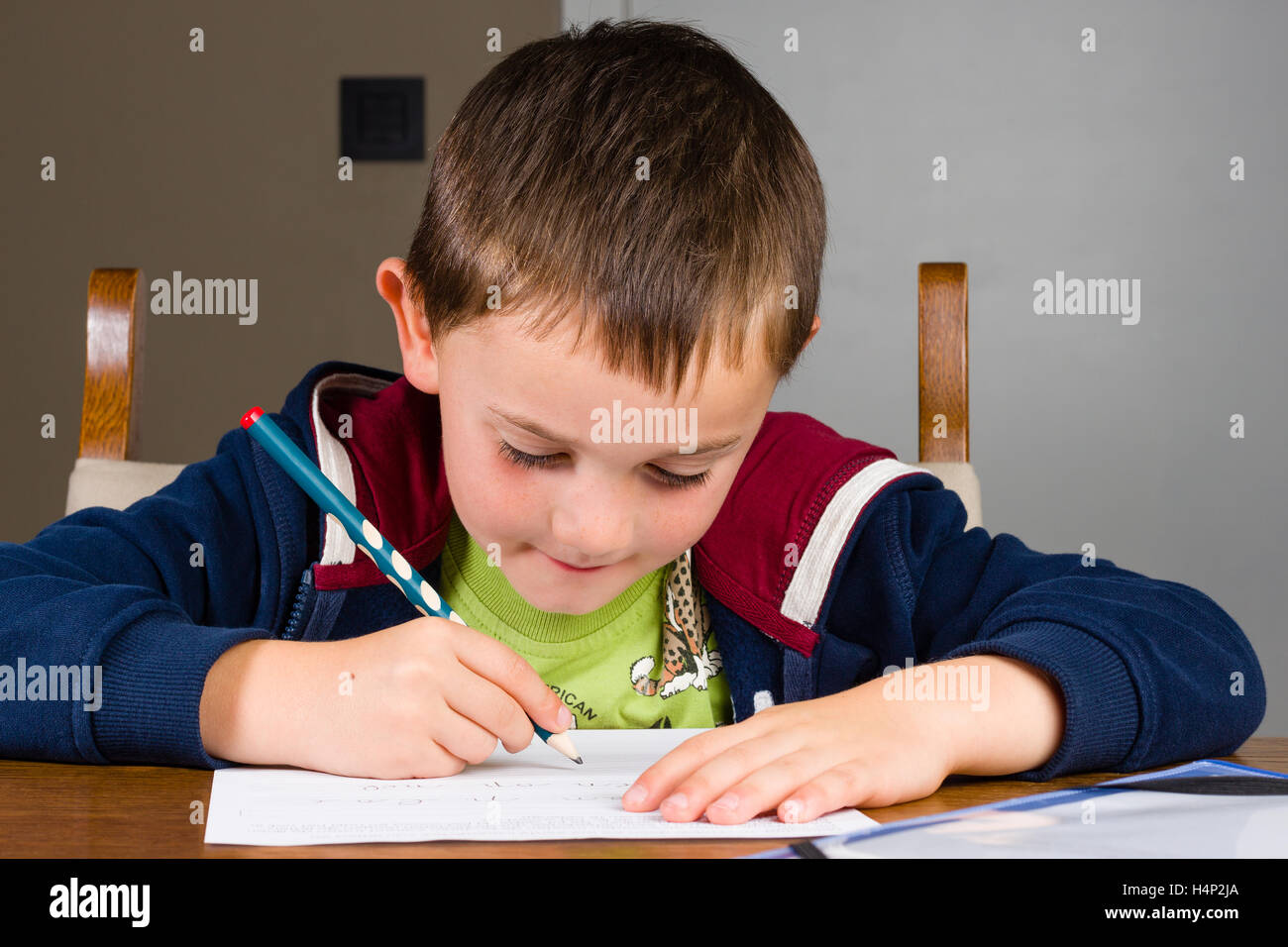Boy doing homework Stock Photo - Alamy