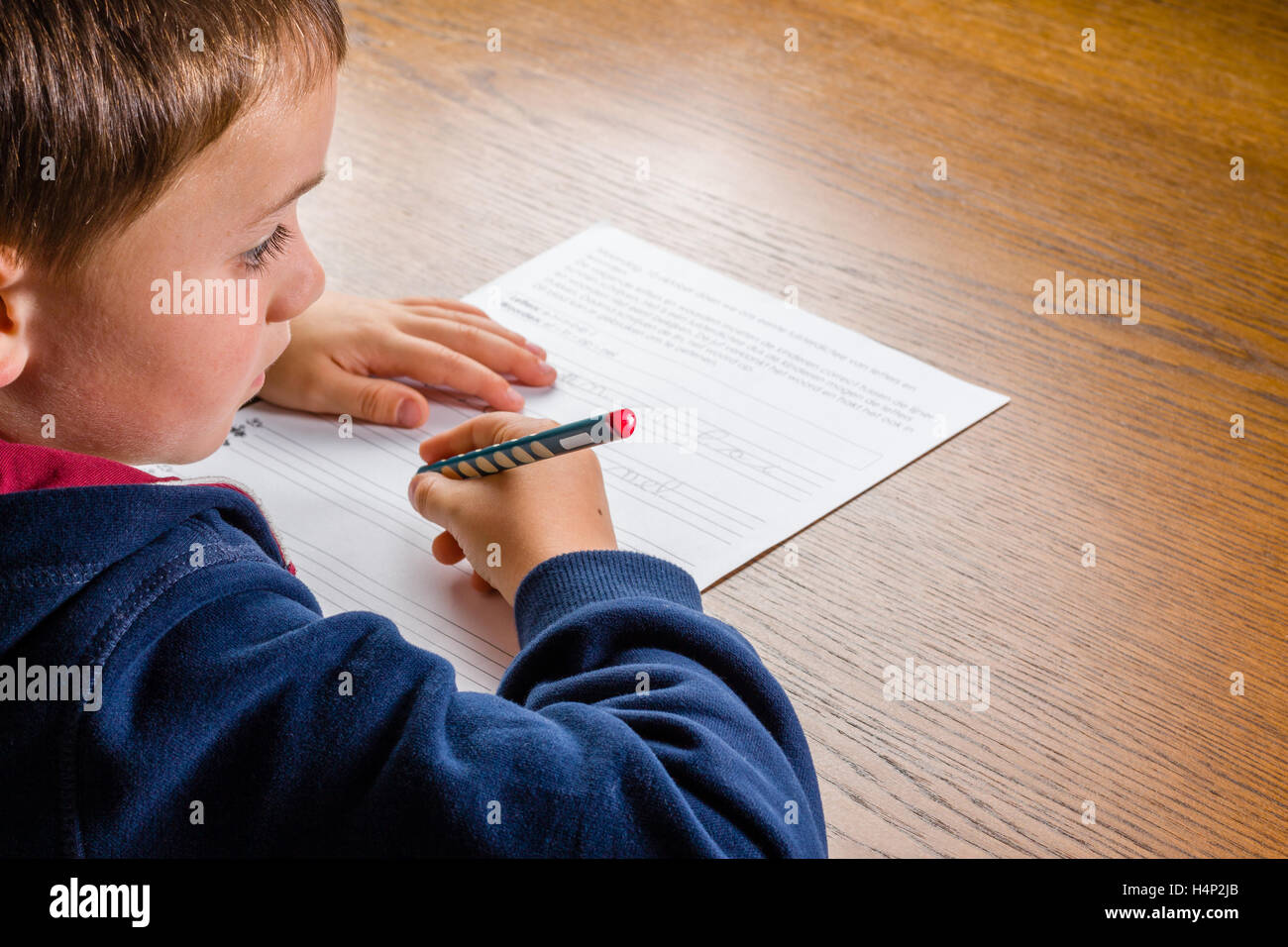 Boy doing homework Stock Photo - Alamy