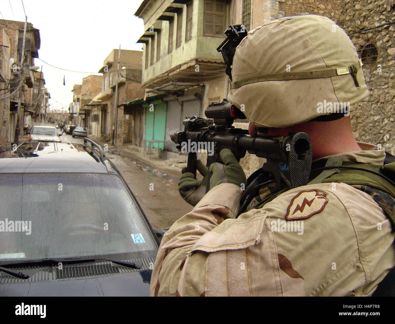 22nd November 2004 A U.S. Army soldier uses his rifle sight to check ...