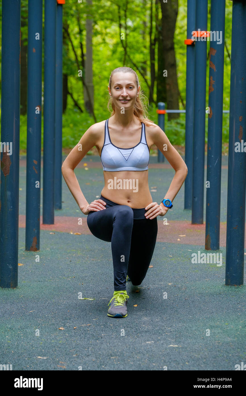 Young slim woman doing workout in a training ground Stock Photo - Alamy
