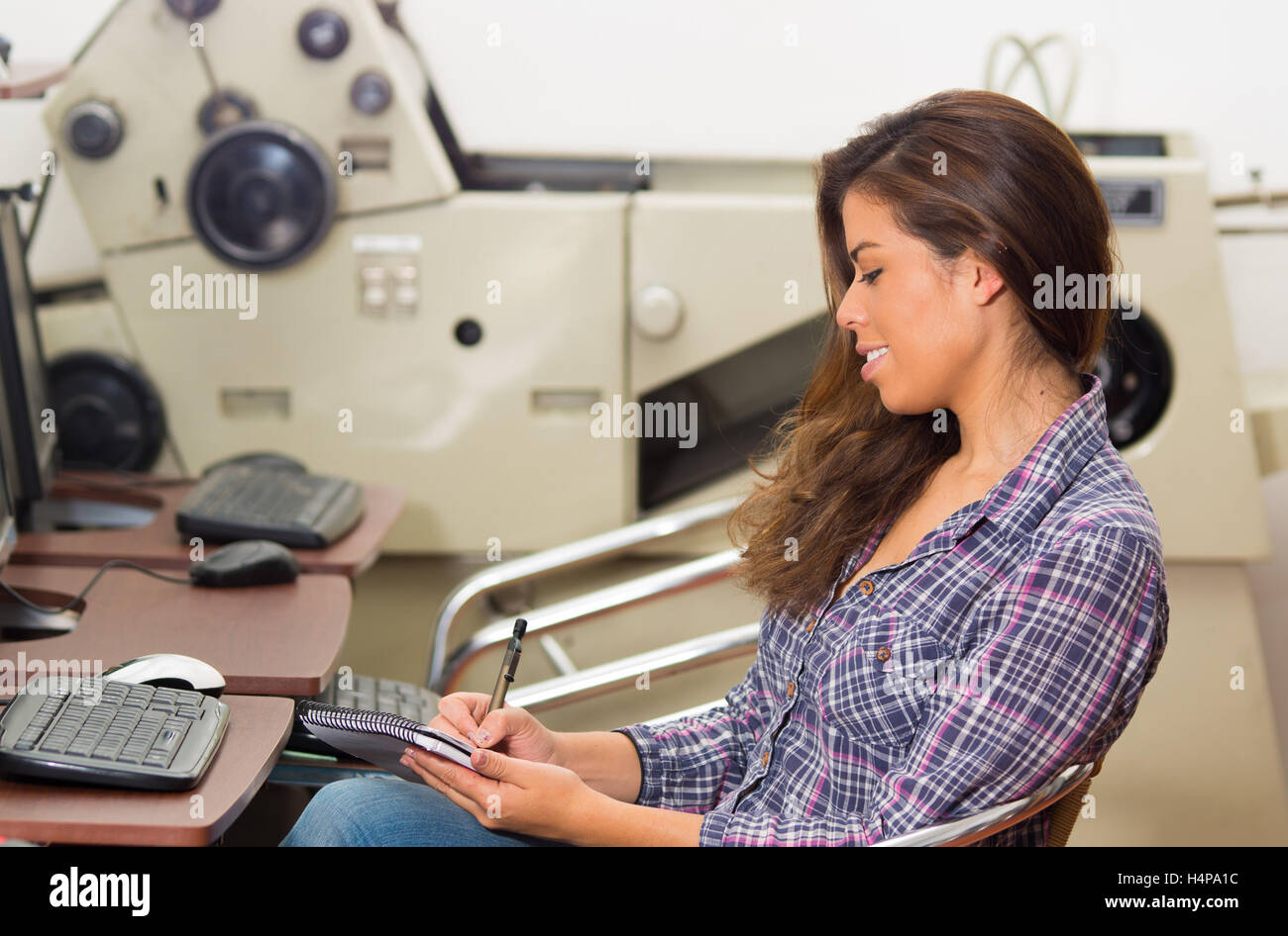 nice girl working with a computer and writting on her notebook Stock ...