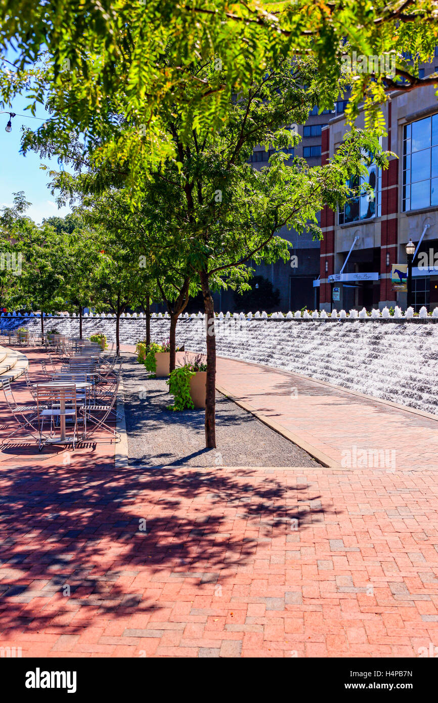 The waterfall, trees and picnic area in Triangle Park in downtown ...