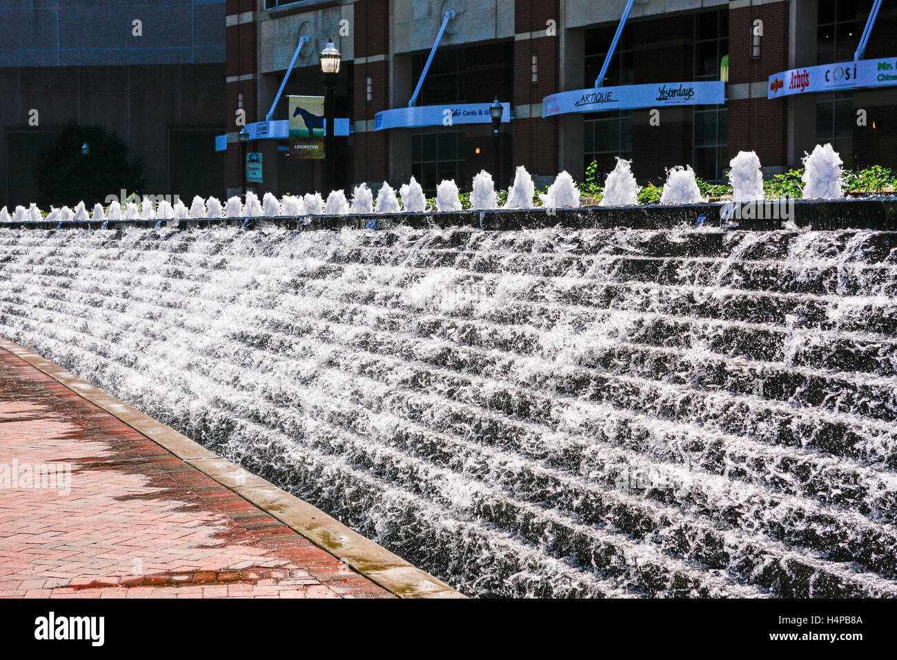 The waterfall, trees and picnic area in Triangle Park in downtown ...