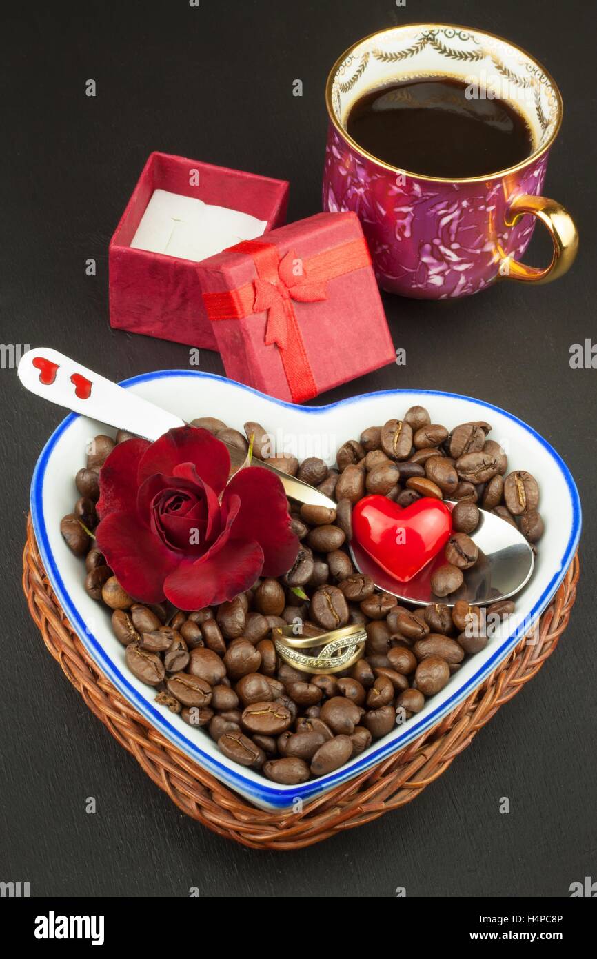 Romantic coffee. Marriage proposal. Coffee beans and a gold ring ...