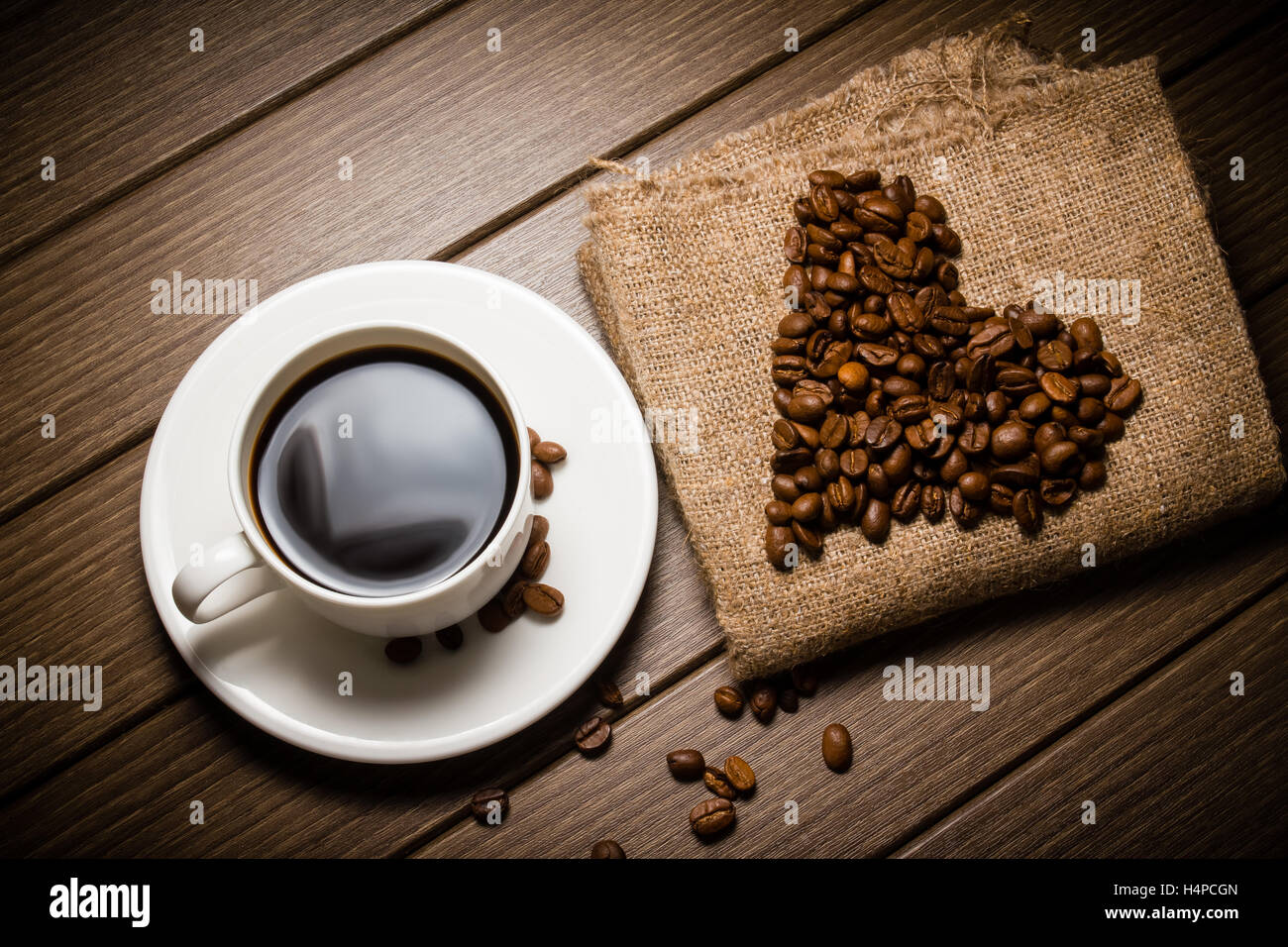 cup of delicious coffee with coffee brown beans Stock Photo - Alamy