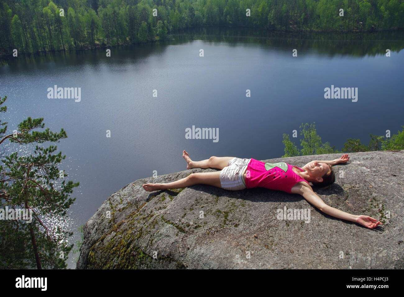 Girl laying on rocks hi-res stock photography and images - Alamy
