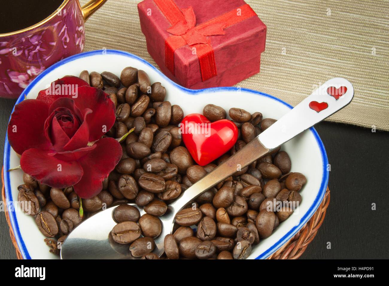 Romantic coffee. Marriage proposal. Coffee beans and a gold ring ...