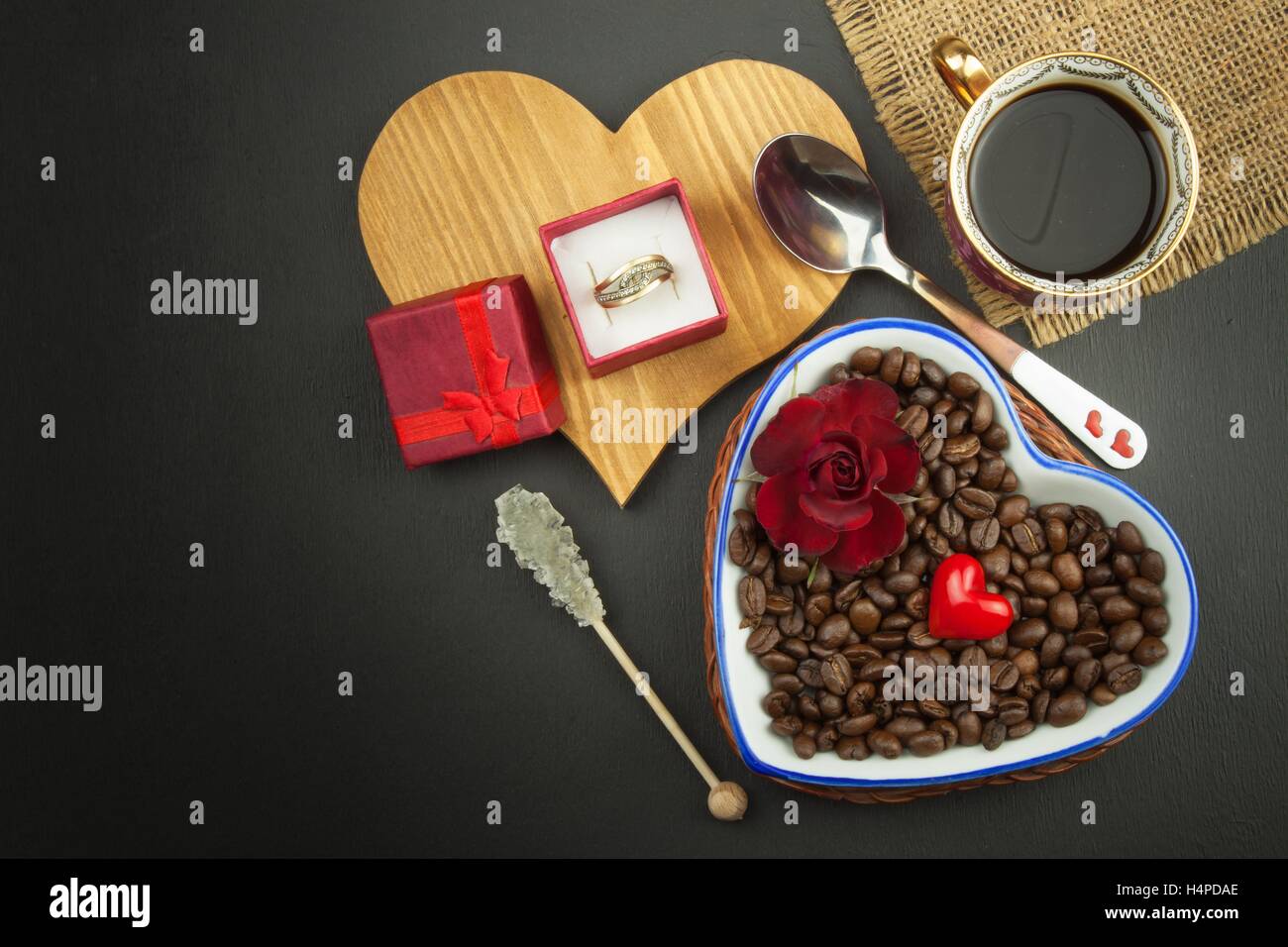 Romantic coffee. Marriage proposal. Coffee beans and a gold ring ...