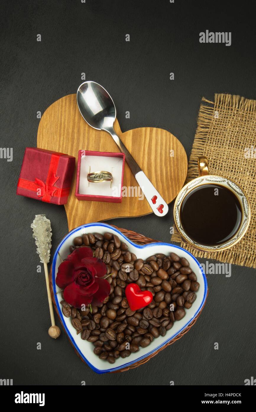 Romantic coffee. Marriage proposal. Coffee beans and a gold ring ...