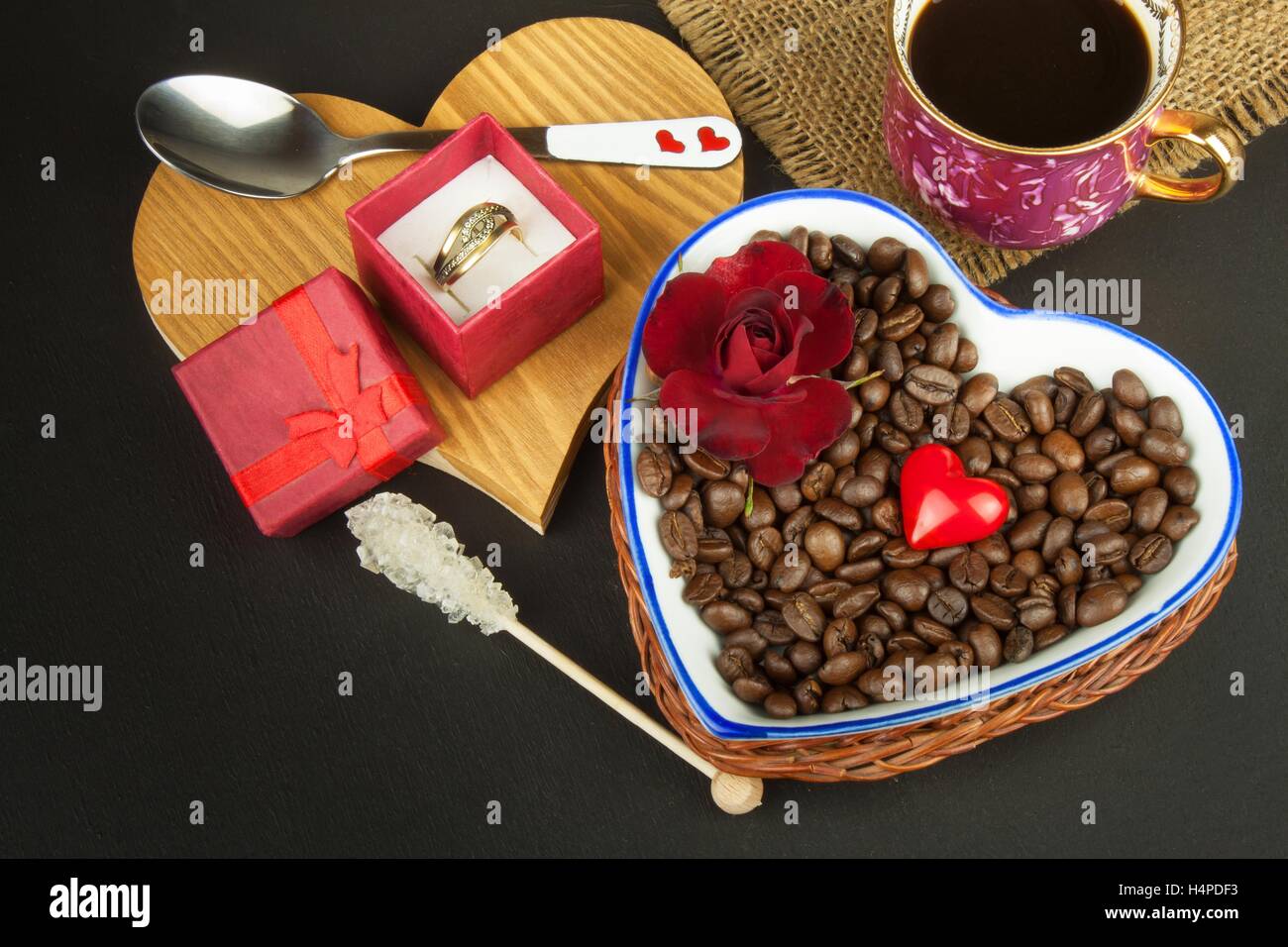 Romantic coffee. Marriage proposal. Coffee beans and a gold ring ...