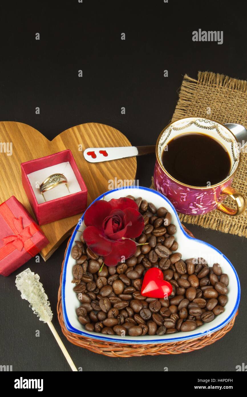 Romantic coffee. Marriage proposal. Coffee beans and a gold ring ...