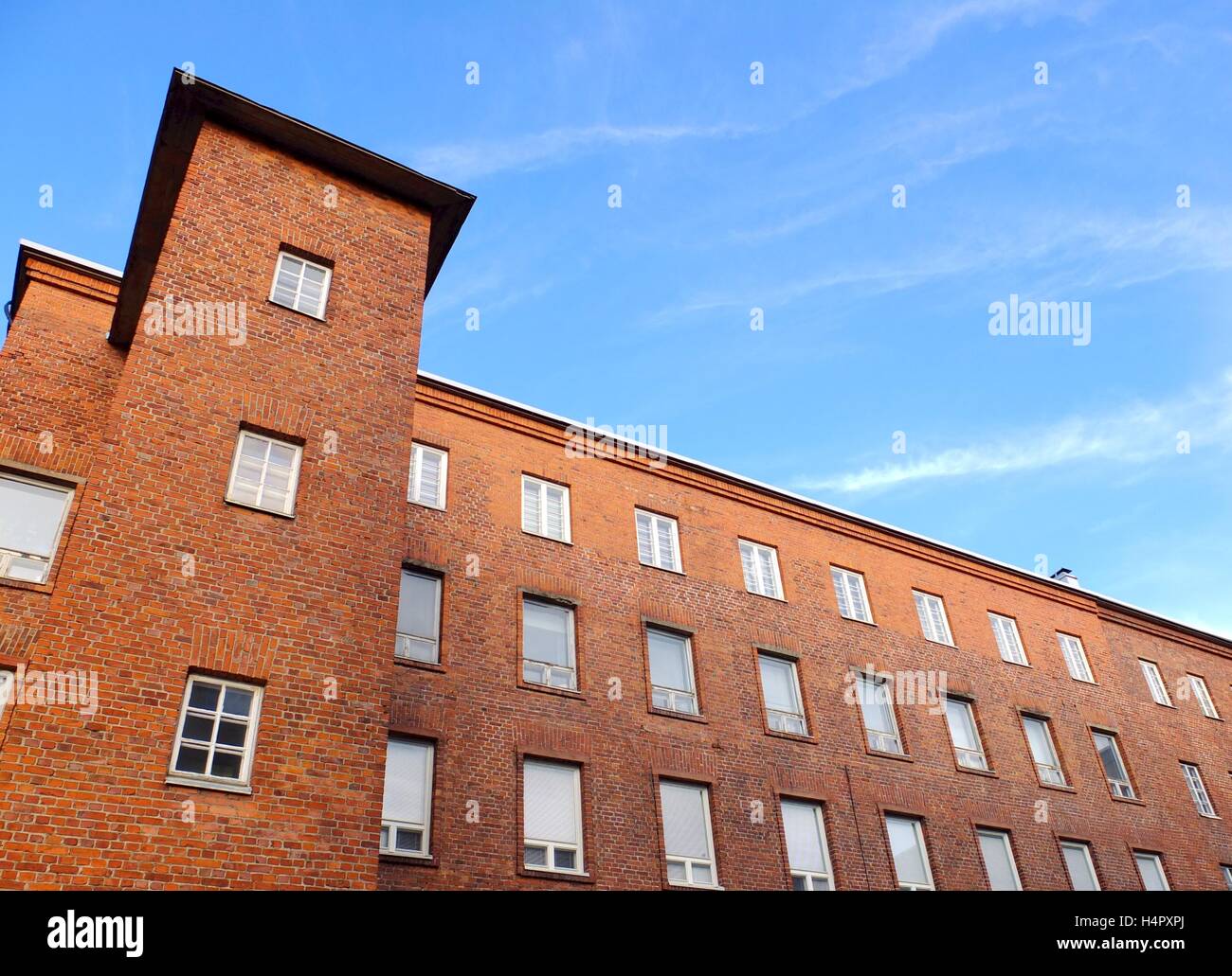 Red brick warehouse with white windows Stock Photo - Alamy