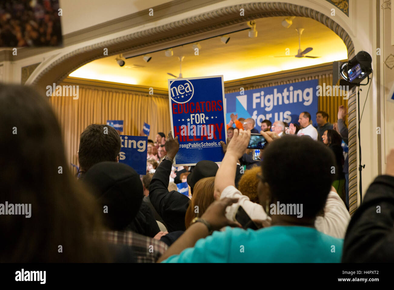 A Hillary supporter holds up a sign saying "Educators For Hillary" as ...