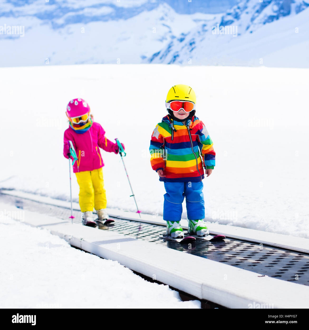 Child skiing in mountains. Active toddler kid with safety helmet ...