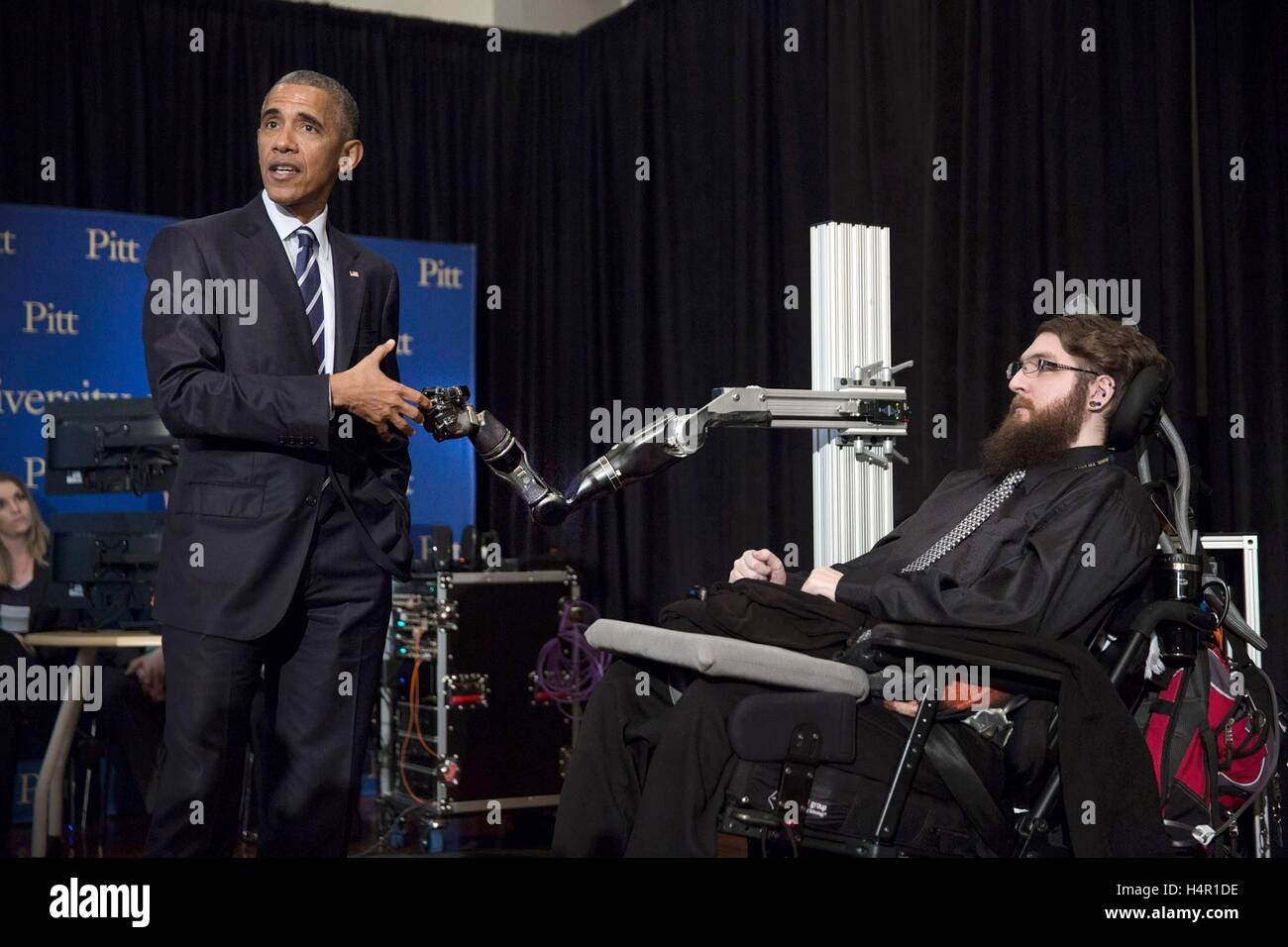 U.S President Barack Obama fist-bumps the robotic arm of Nathan ...