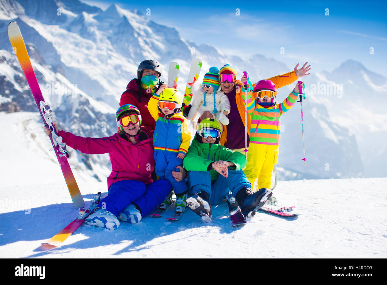Family ski vacation. Group of skiers in Swiss Alps mountains. Adults ...