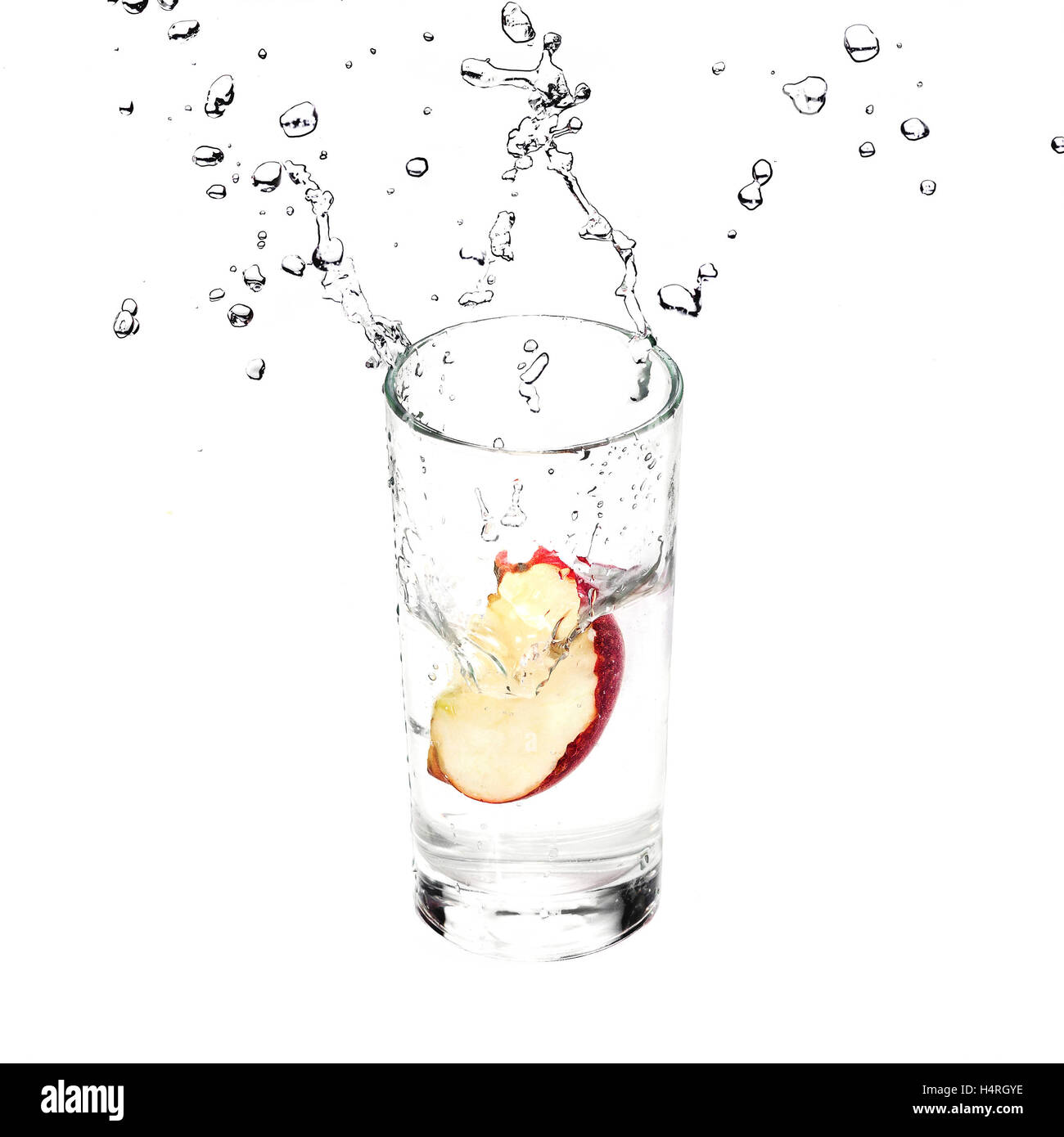 Fresh Apple is splashing in glass with pure water isolated on white ...