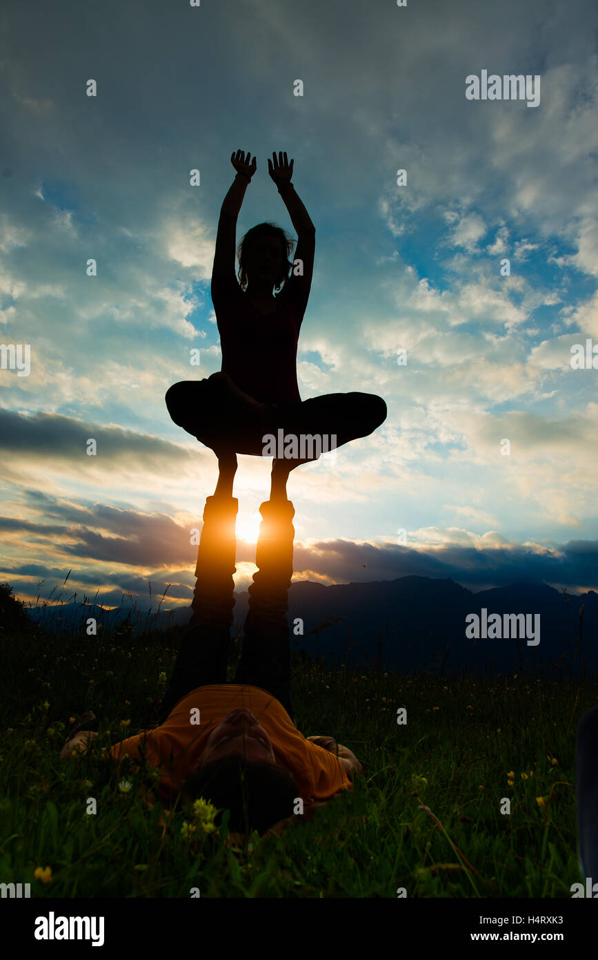 Acroyoga girl of male in romantic atmosphere in the nature in the ...
