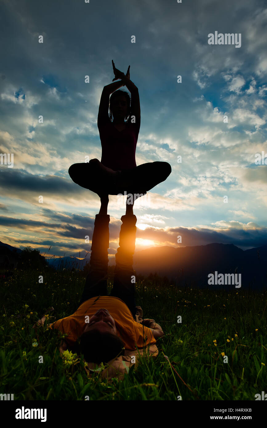 Acroyoga girl of male in romantic atmosphere in the nature in the ...
