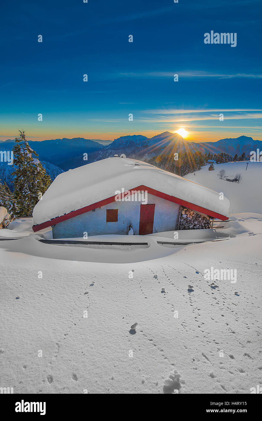 Alpin hut in the snow during sunset Stock Photo - Alamy
