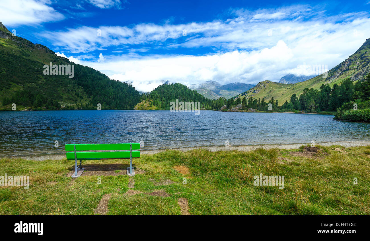 Bench in front of an alpine lake in the Swiss Alps Stock Photo - Alamy