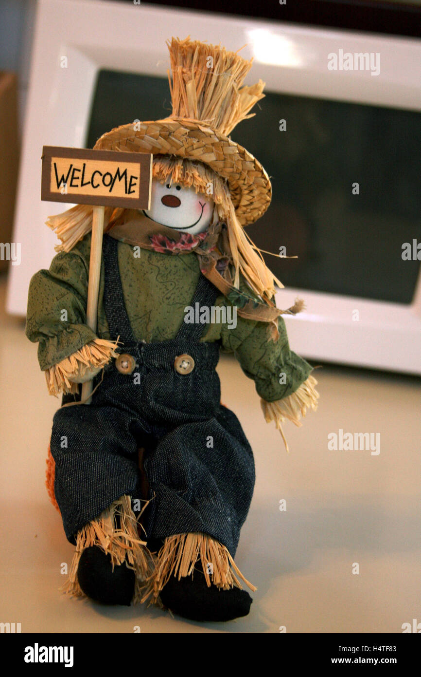 Cute small scarecrow as welcome sign fall decoration Stock Photo - Alamy