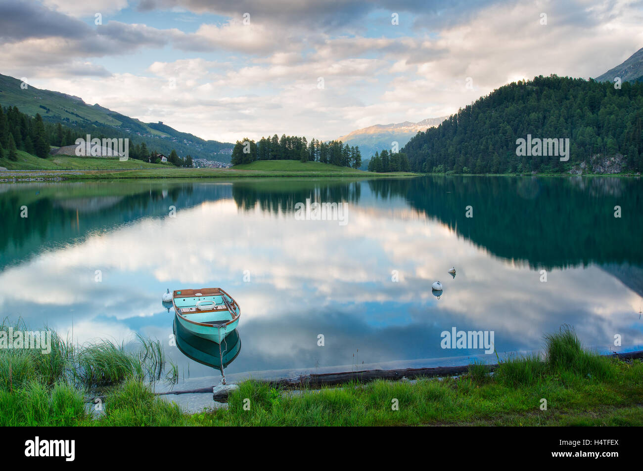 Boat moored in an alpine lake in the Swiss Alps Stock Photo - Alamy