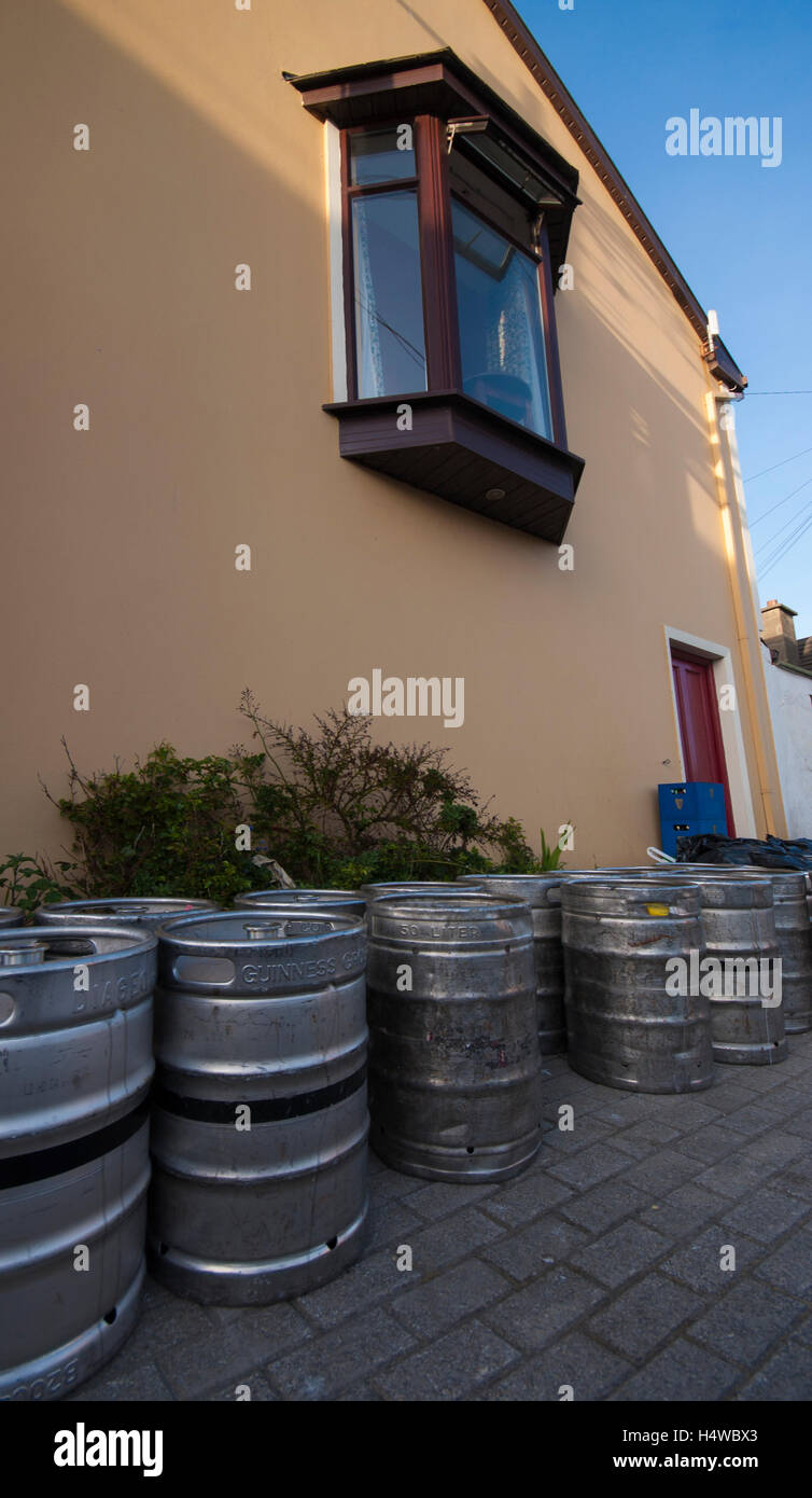 Empty kegs sit on the sidewalk behind a pub in Kilkee, County Clare ...