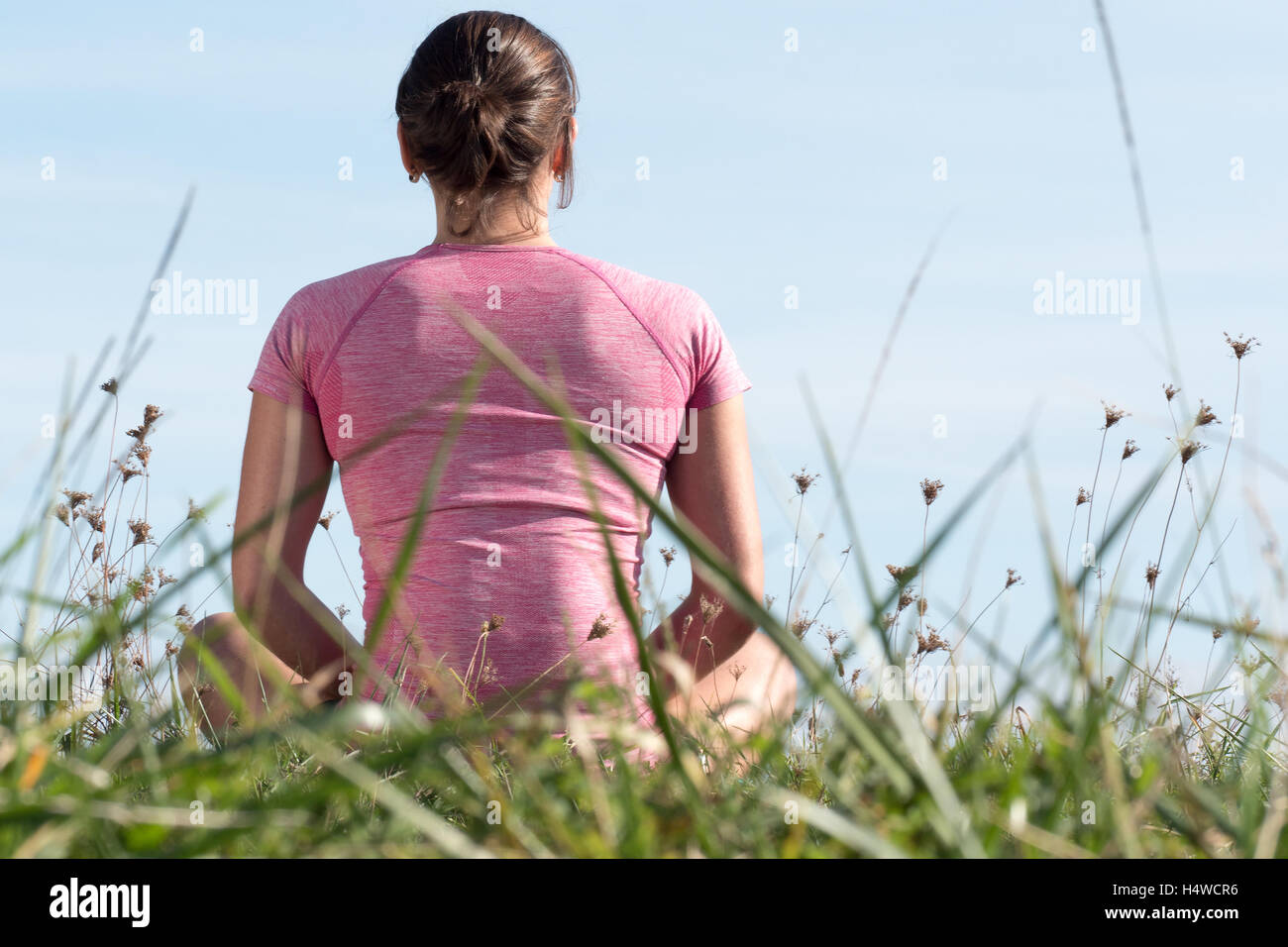 young sporty woman with a pink sportswear, back view Stock Photo - Alamy
