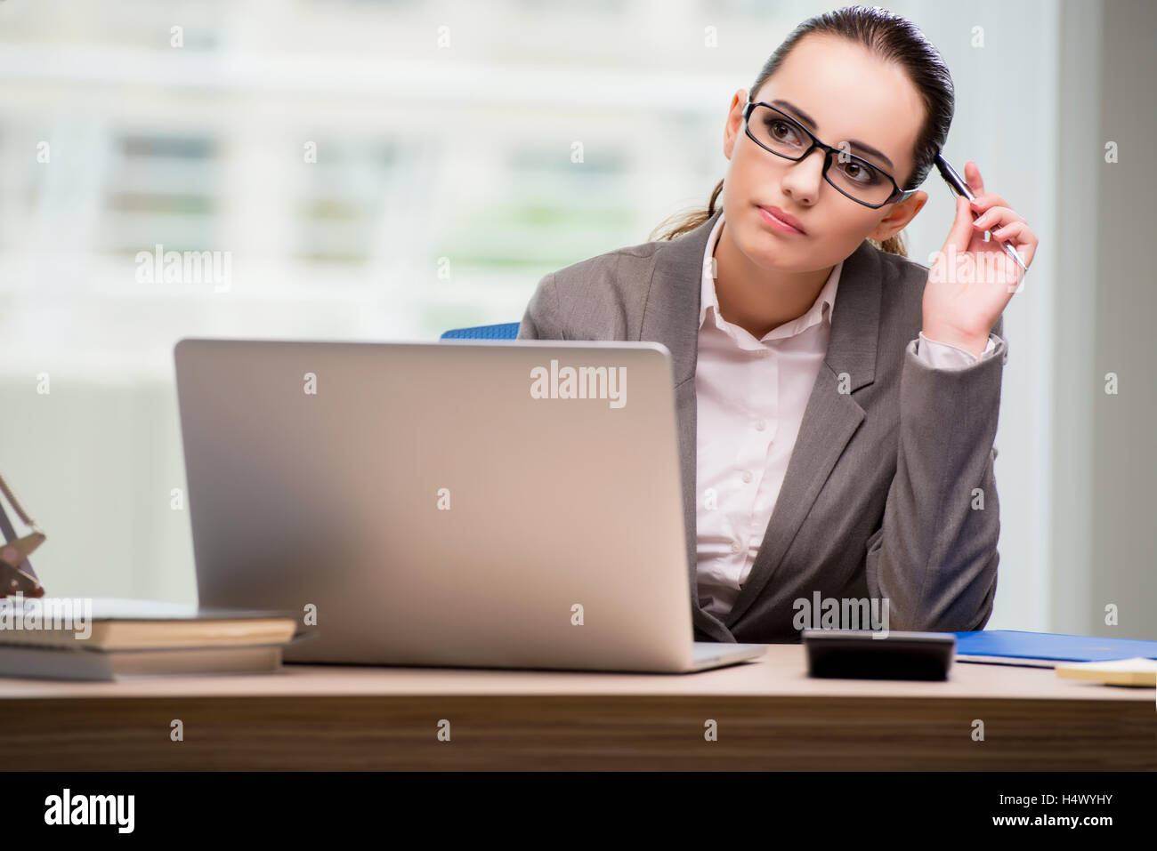 Sad businesswoman working at her desk Stock Photo - Alamy