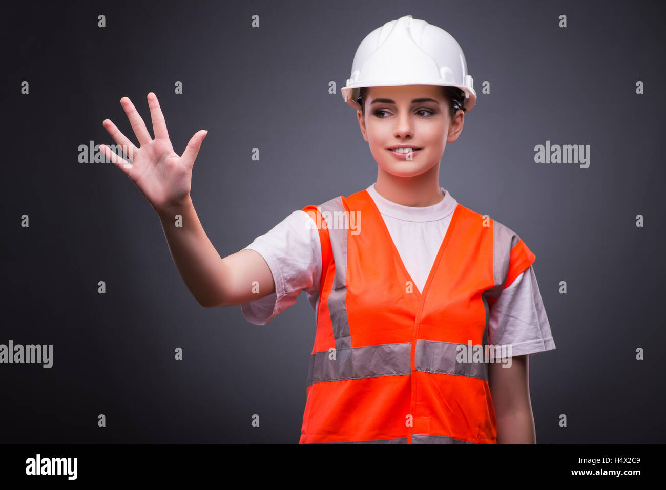Cute construction worker pressing virtual buttons Stock Photo - Alamy
