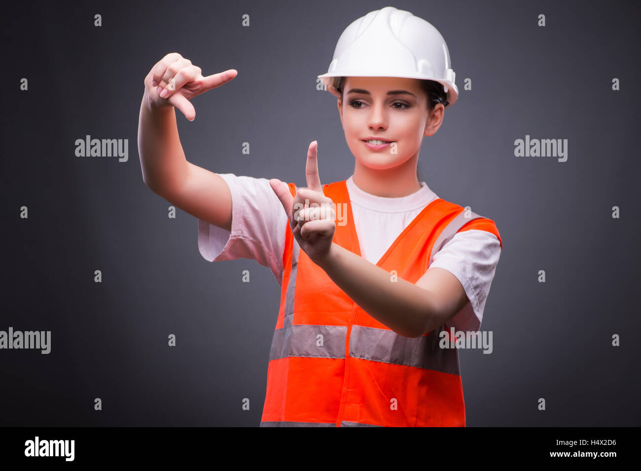 Cute construction worker pressing virtual buttons Stock Photo - Alamy