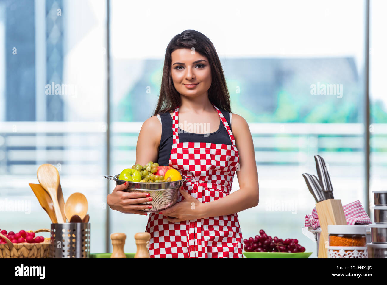 Young cook with fruits in the kitchen Stock Photo - Alamy