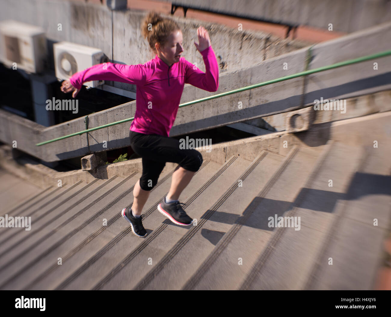 sporty woman running onsteps at early morning jogging Stock Photo - Alamy