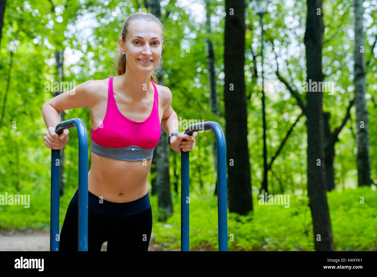 Young slim woman doing workout in a training ground Stock Photo - Alamy